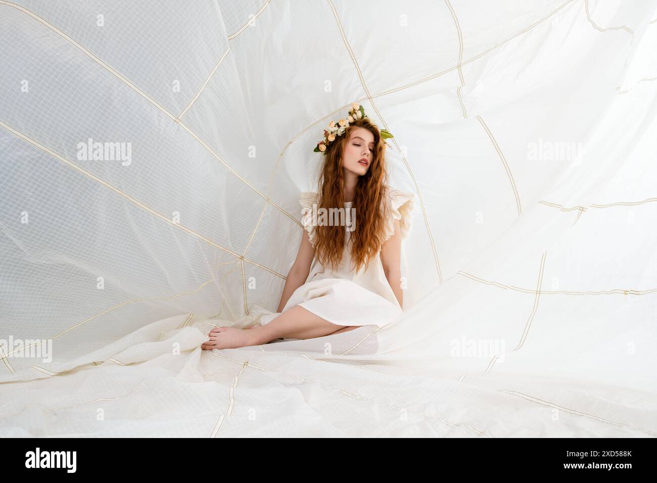 Young Woman in White Dress Sitting Underneath a White Fabric Structure ...