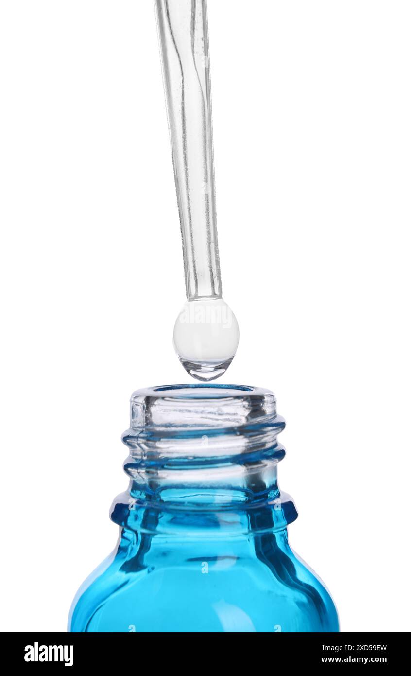 Dripping liquid from pipette into bottle isolated on white, closeup ...