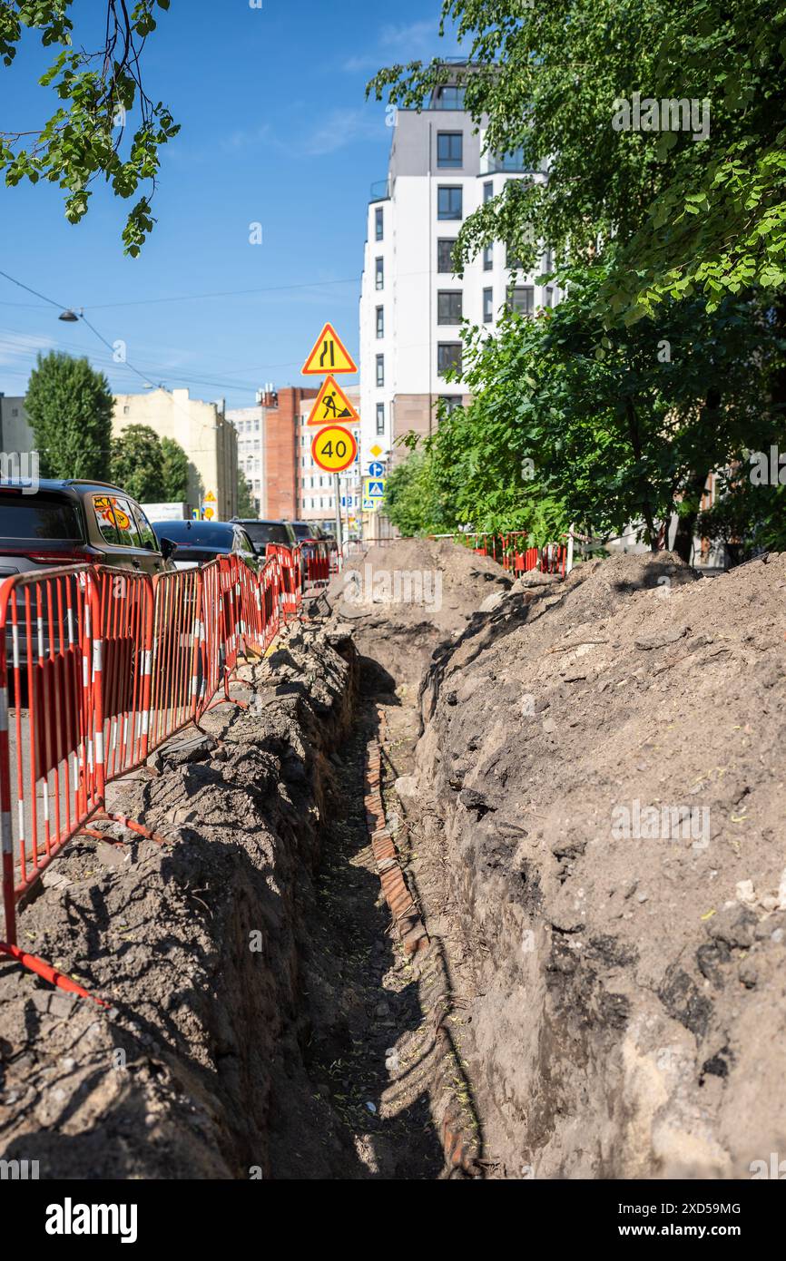 Trench for laying electrical cables in city road, utility works for ...