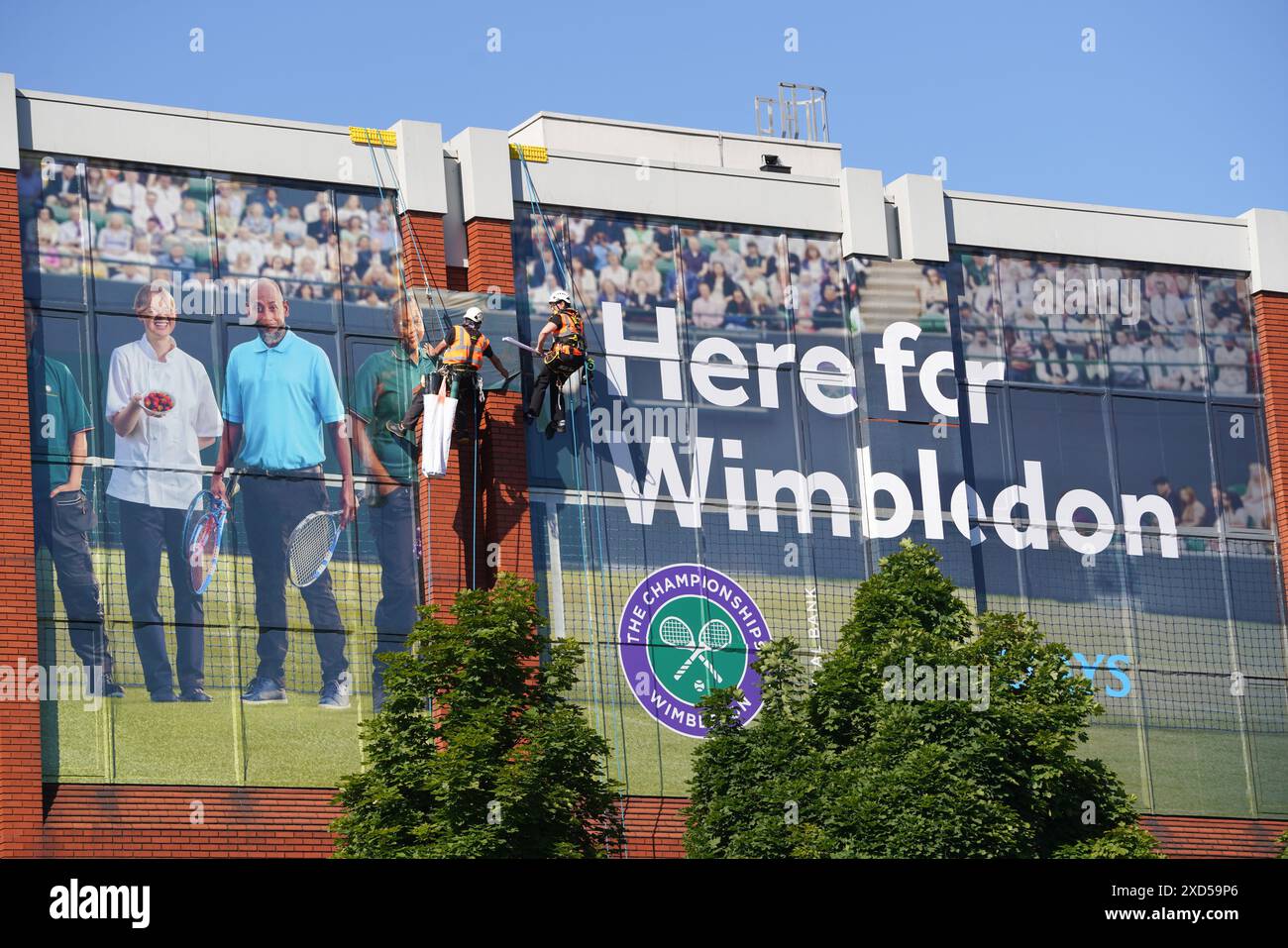 London, UK. 20 June.2024. A building in Wimbledon town centre is covered with giant hoarding ...