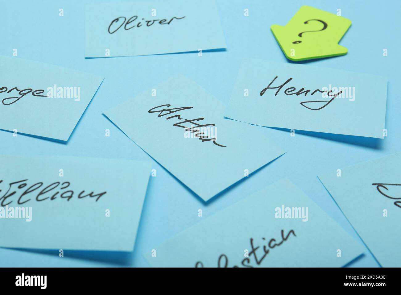 Choosing baby name. Paper stickers with different names and question ...