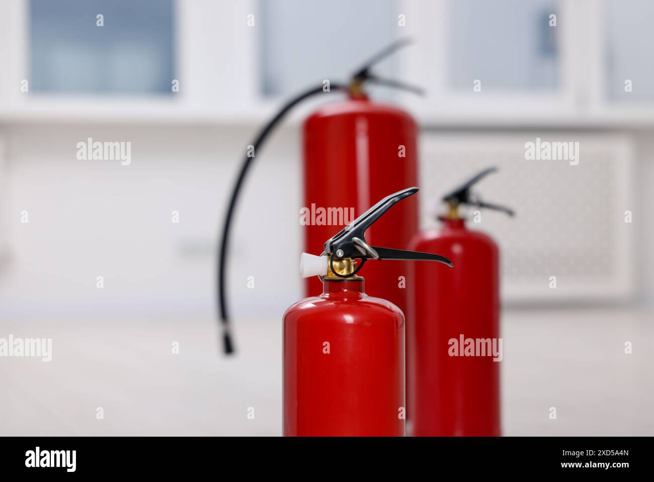Fire extinguisher indoors, closeup view. Safety equipment Stock Photo ...