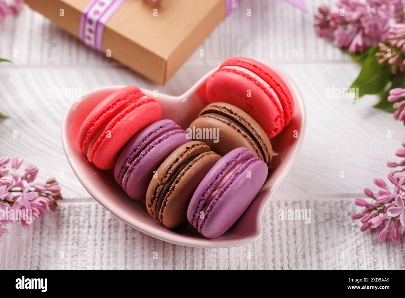 Colorful macaroons in heart shaped bowl, arranged in a delightful ...