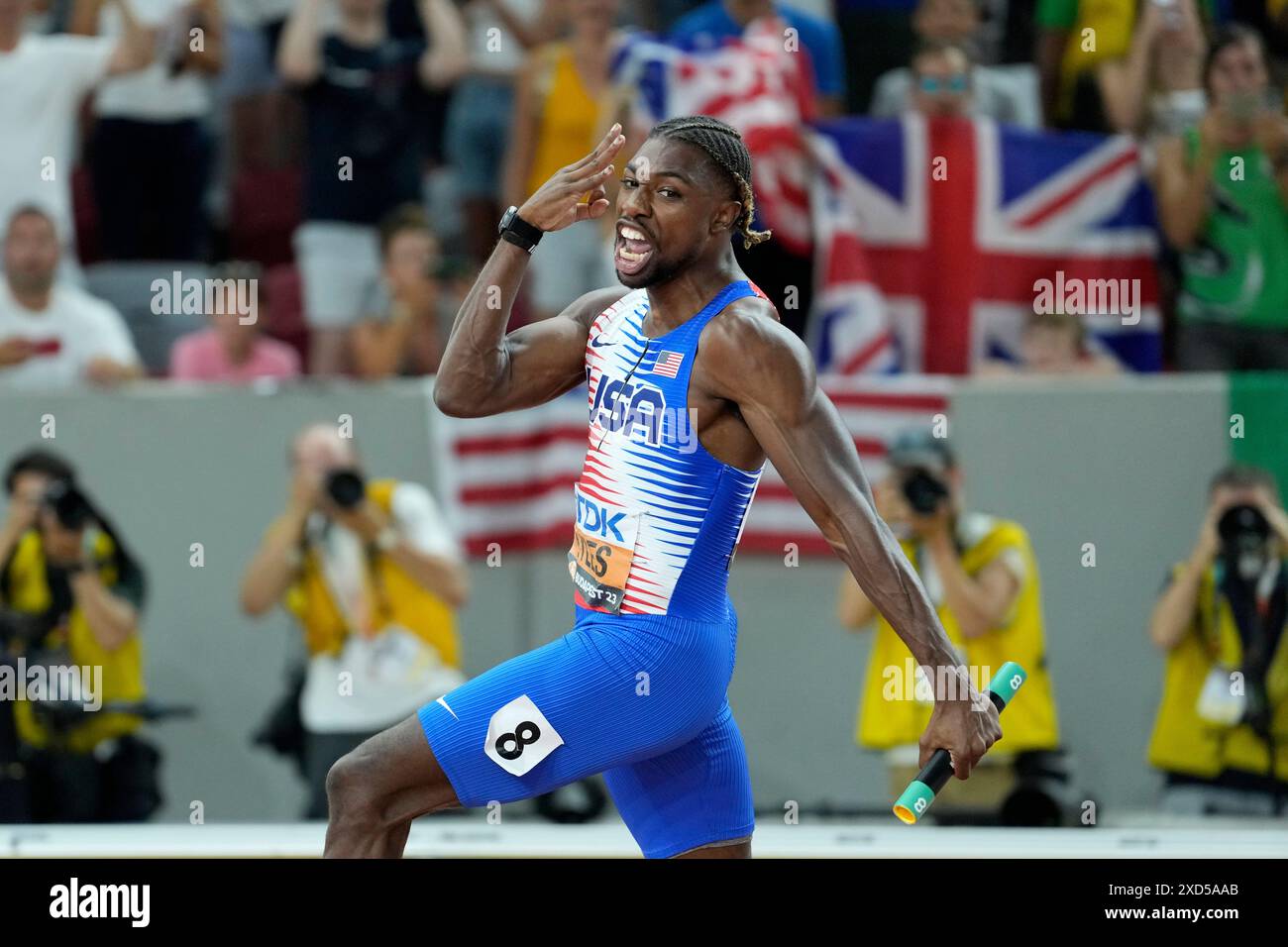 FILE - Noah Lyles, from the United States, gestures after crossing the ...