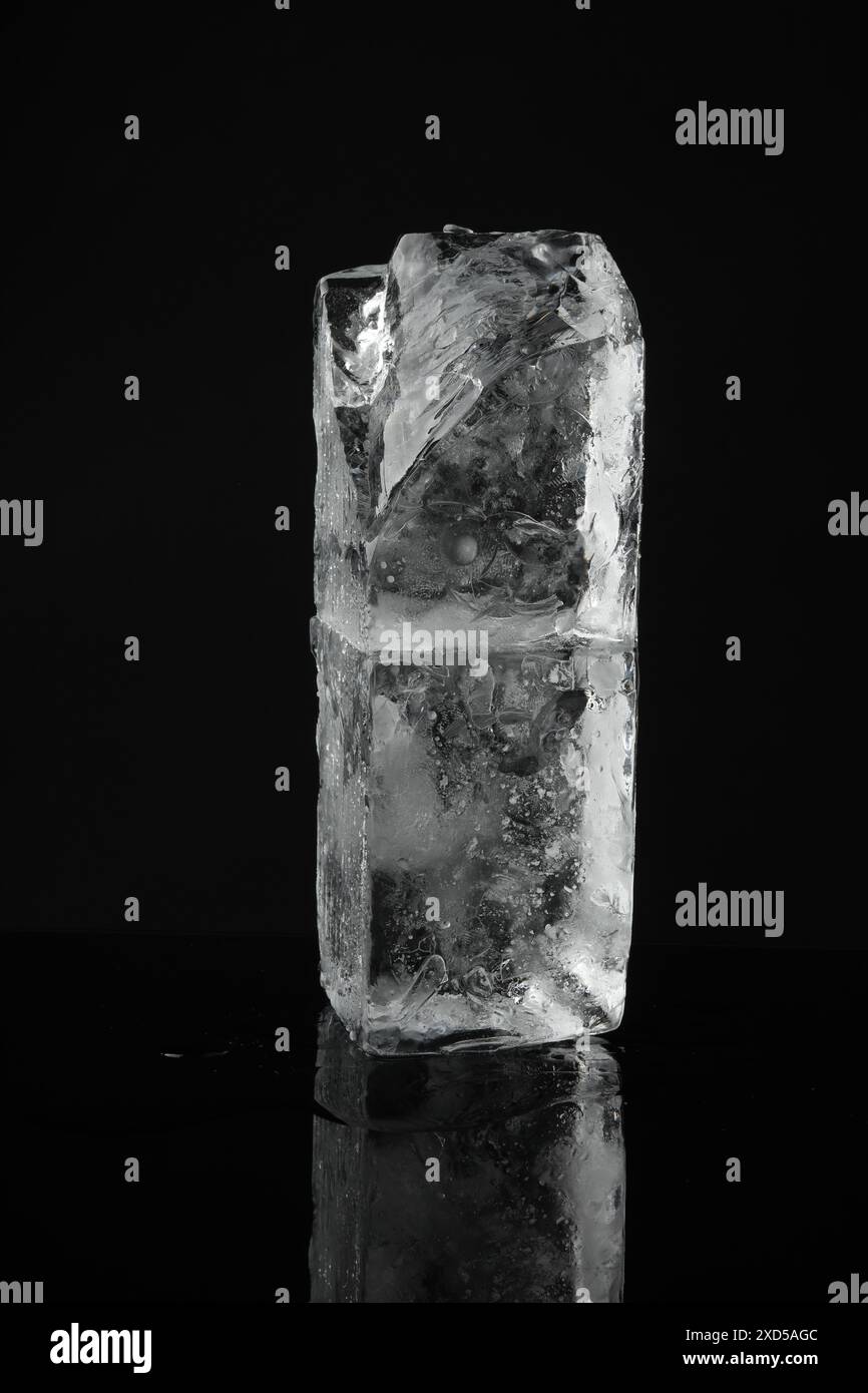 Blocks of clear ice on black mirror surface Stock Photo - Alamy