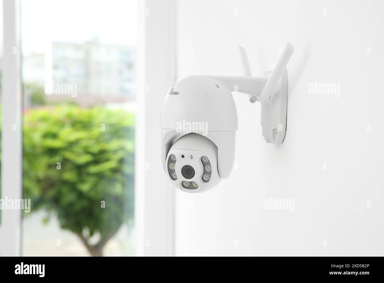 Modern CCTV camera on white wall indoors Stock Photo - Alamy