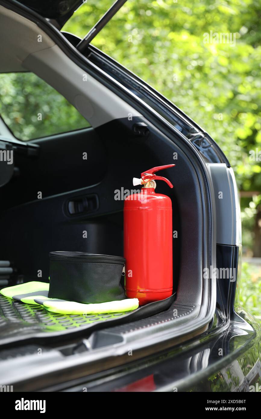 Red fire extinguisher in trunk. Car safety equipment Stock Photo - Alamy