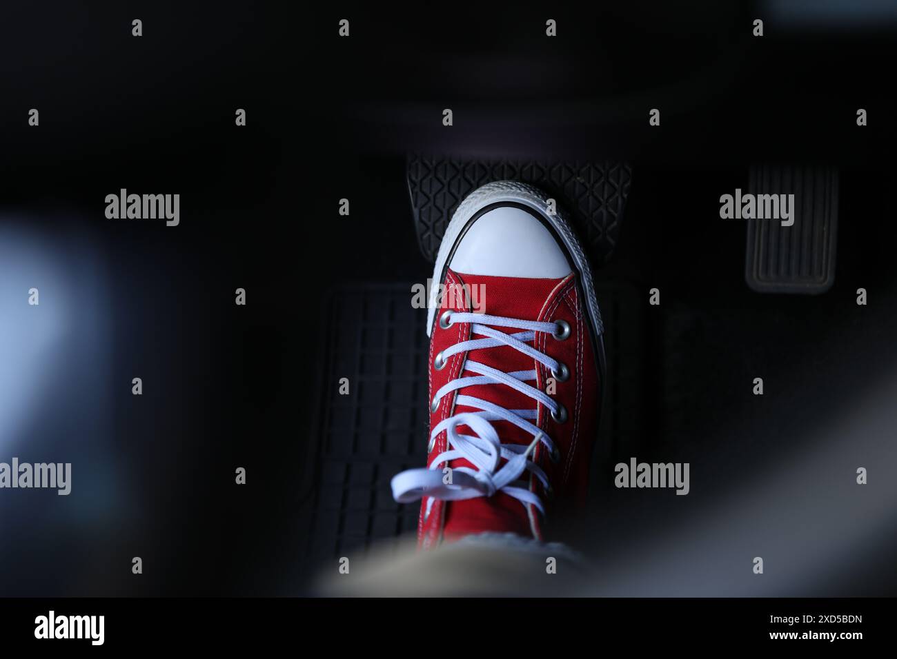 Woman pushing on pedal of car brake, closeup Stock Photo - Alamy
