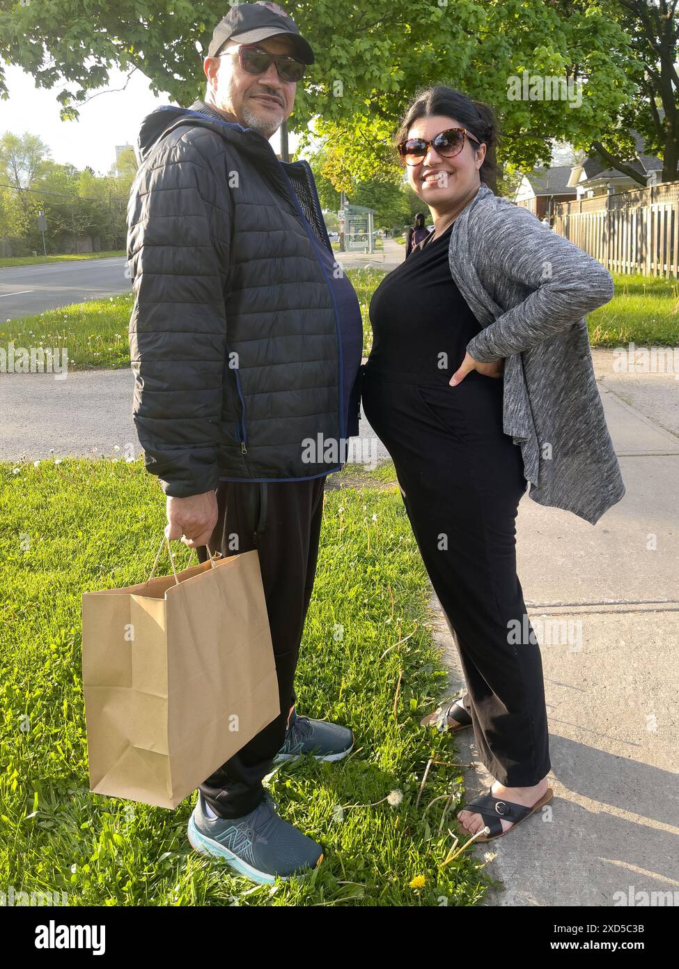 Father with pregnant daughter, portrait on the sidewalk, Toronto ...