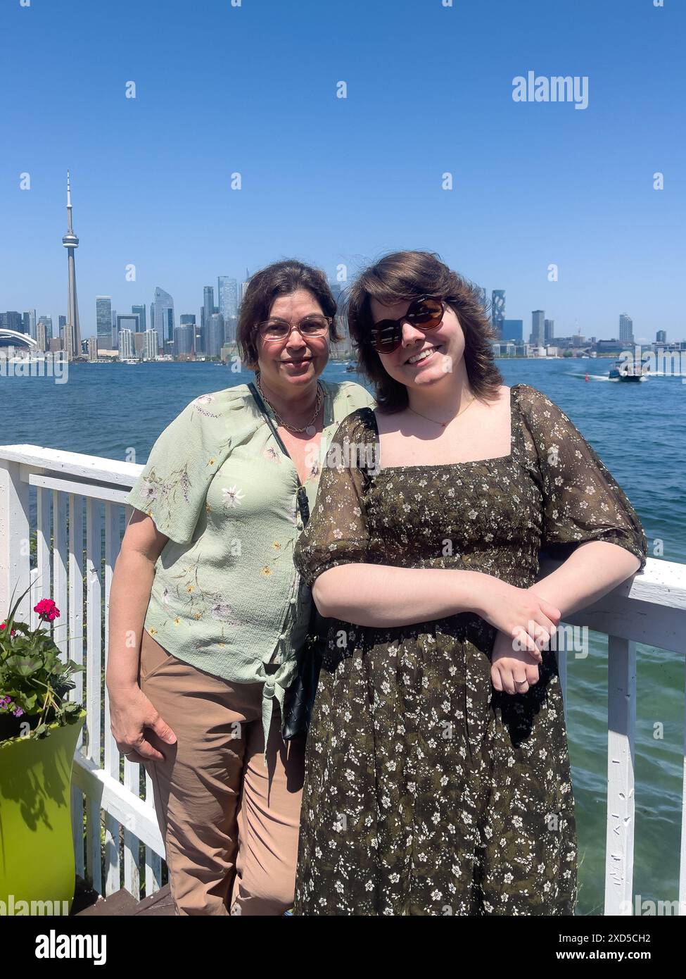Portrait of two women in Centre Island, Toronto cityscape in the ...