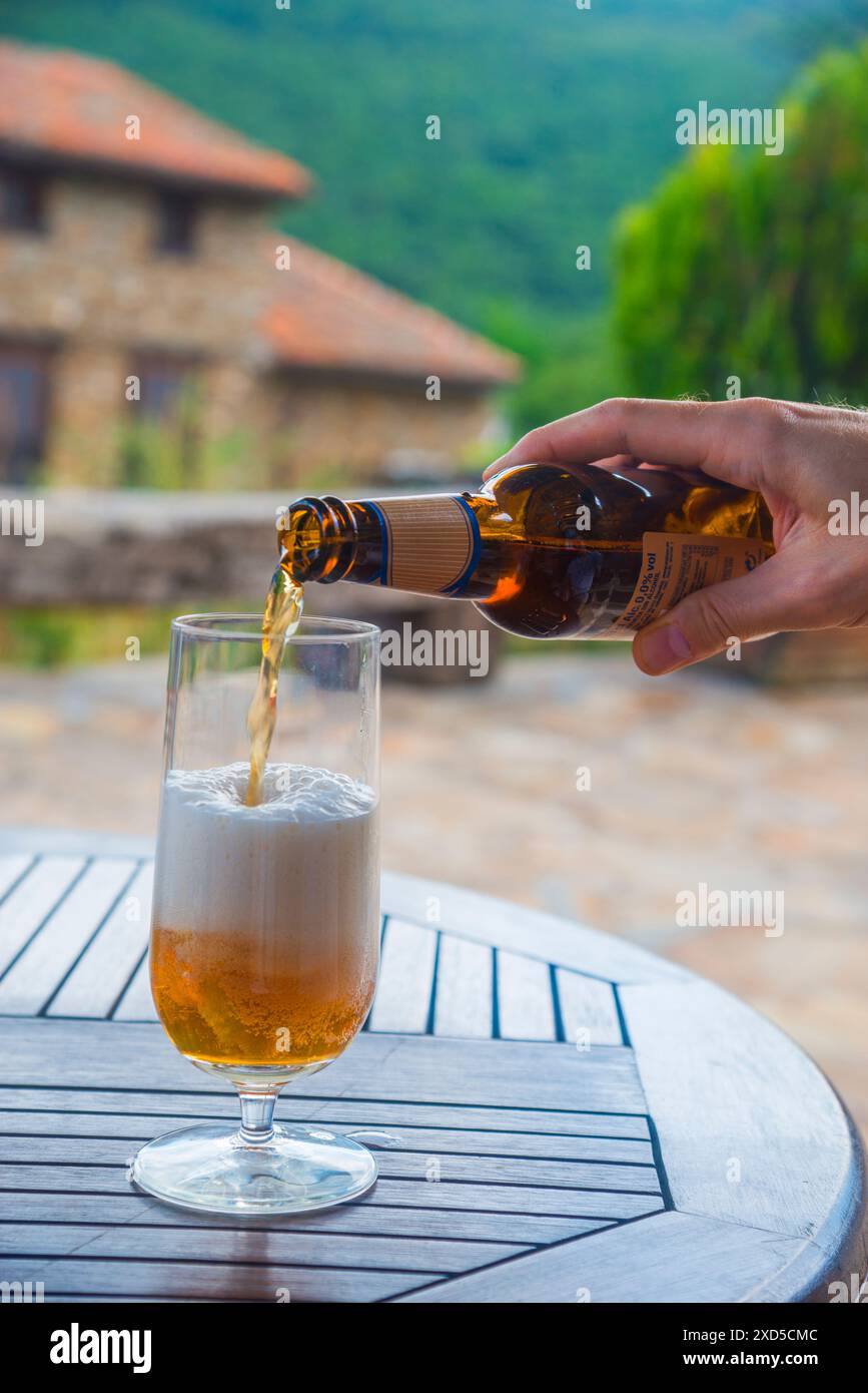 Hand pouring beer in a glass Stock Photo - Alamy