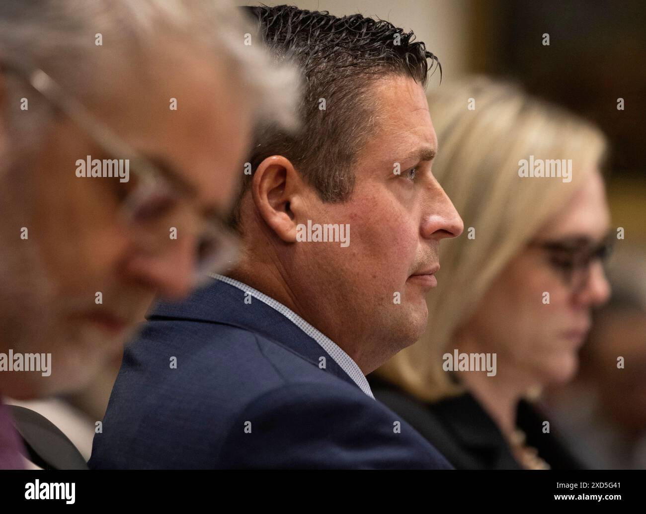 Auburn Police Officer Jeffrey Nelson, center, is flanked by two of his ...