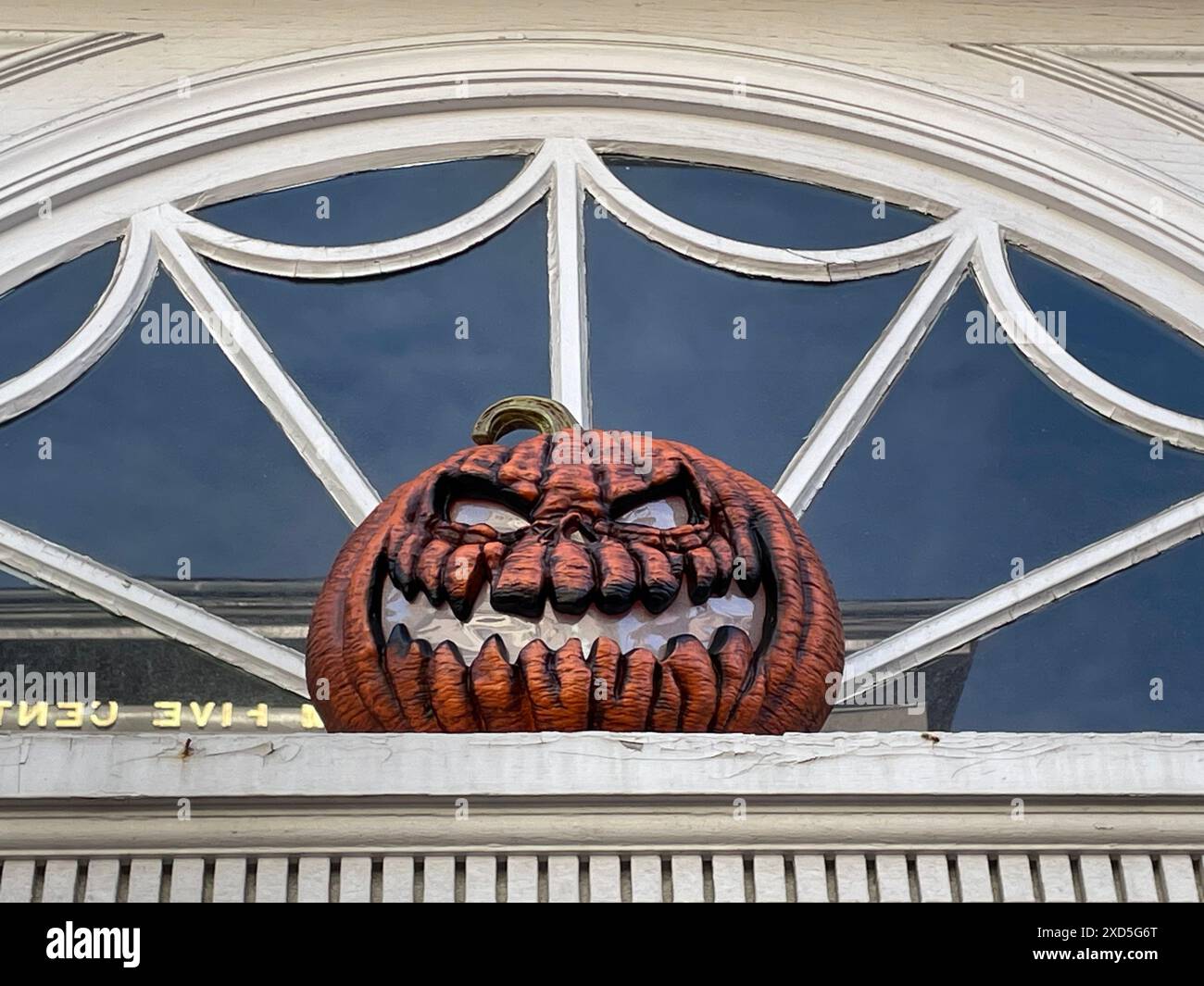 A scary Halloween pumpkin with an evil looking jack o’lantern face ...