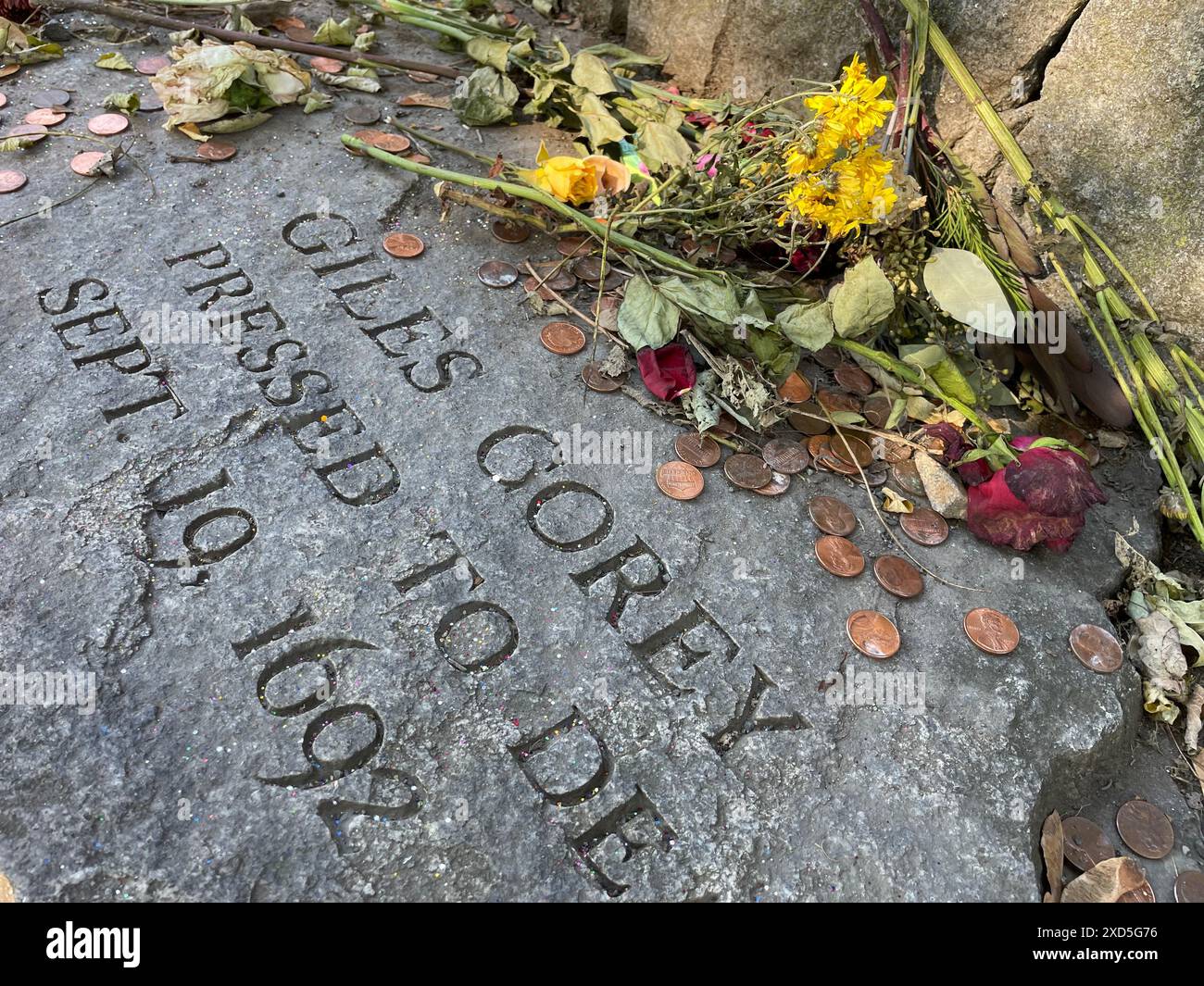 A stone memorial covered with flowers remembers Giles Corey, a man ...