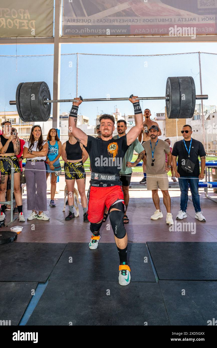 Athletes performing weightlifting in an intense CrossFit competition ...