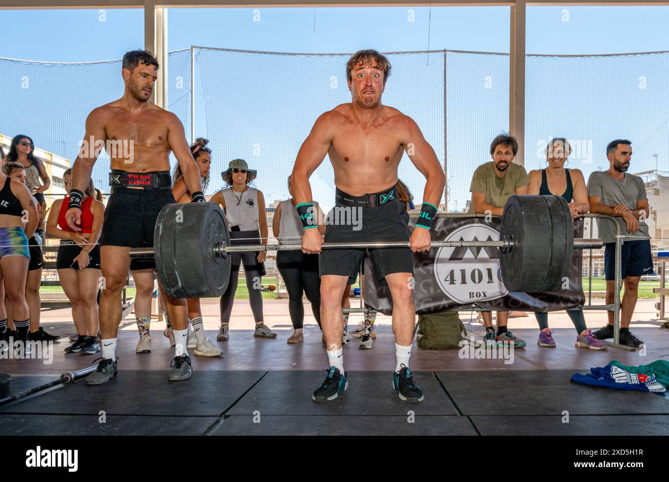 Athletes performing weightlifting in an intense CrossFit competition ...