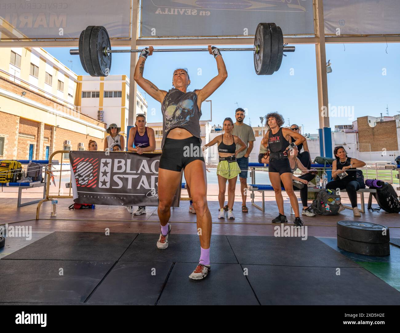 Participants lifting heavy weights during a crossfit competition in ...