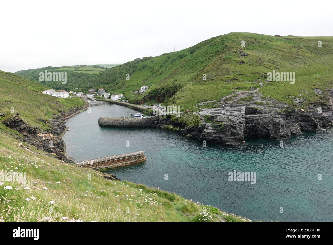 03 June 2024, Great Britain, Boscastle: Natural stone harbor walls ...