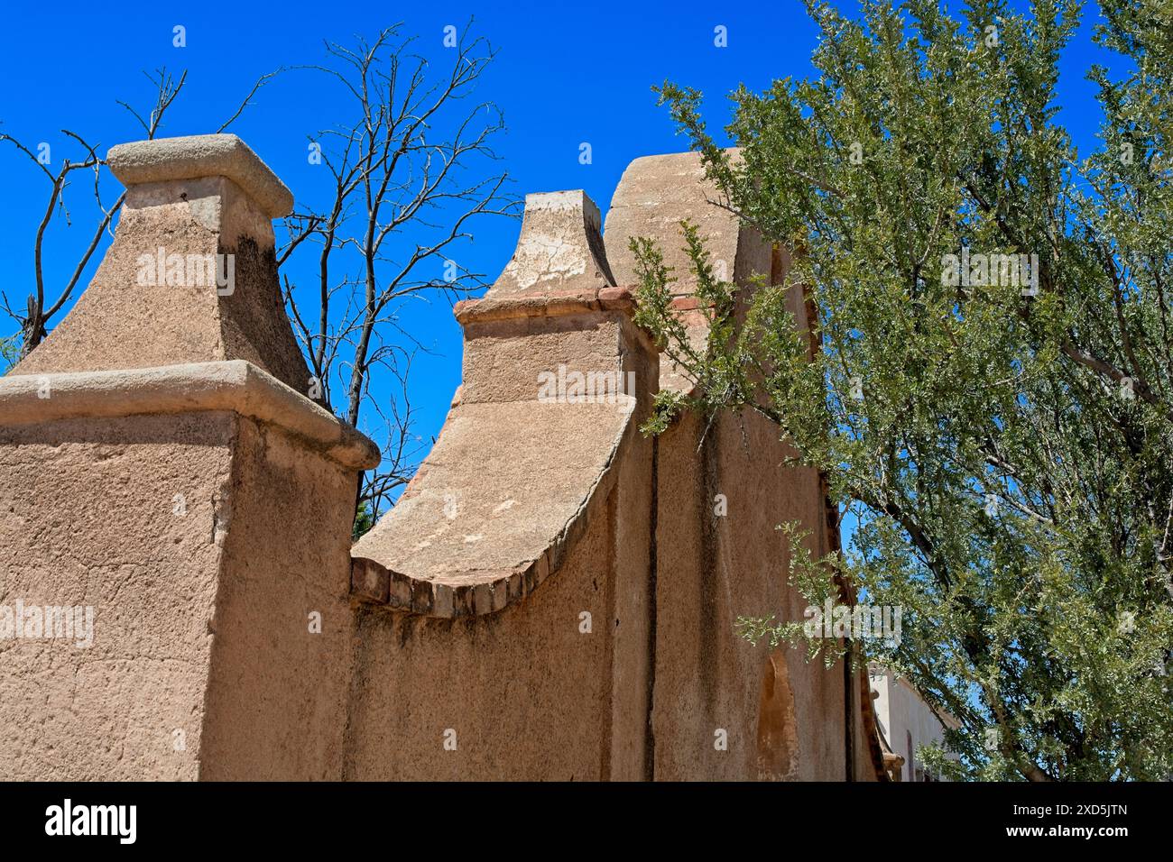 Ancient stucco coated adobe security wall around courtyard at San ...