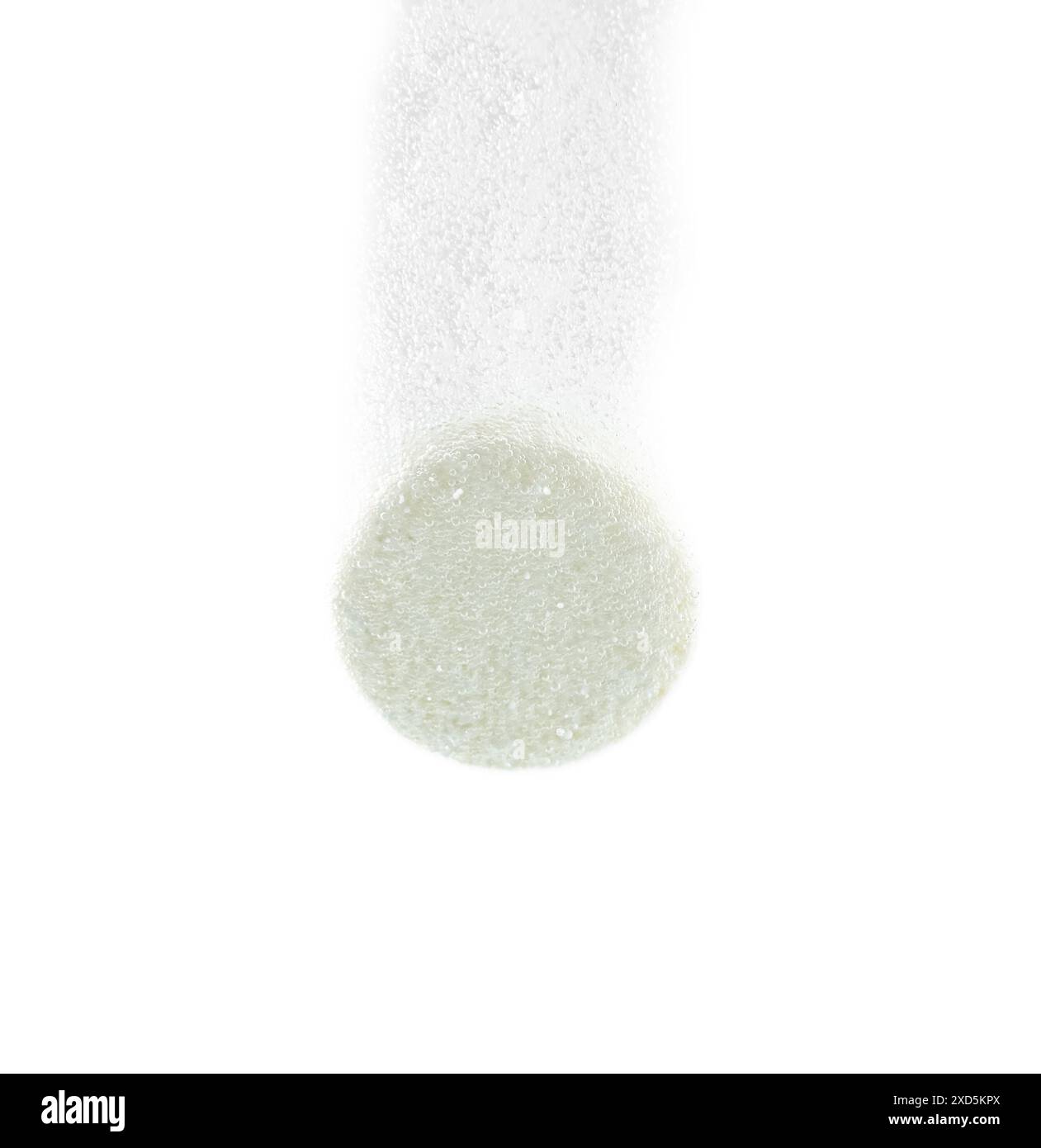 Effervescent pill dissolving in water on light background, closeup ...