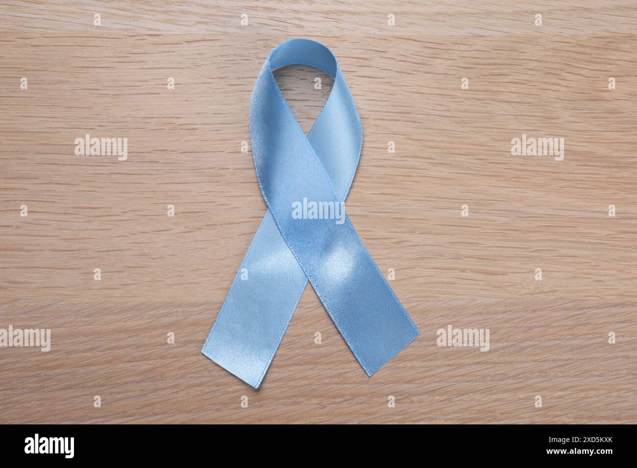 International Psoriasis Day. Ribbon as symbol of support on wooden ...