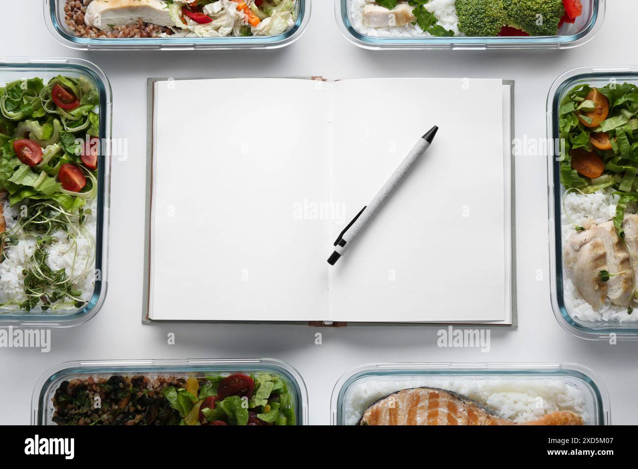 Healthy food. Open notebook, pen and different meals on white ...