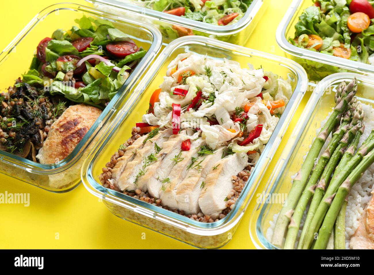 Healthy food. Different meals in glass containers on yellow background ...