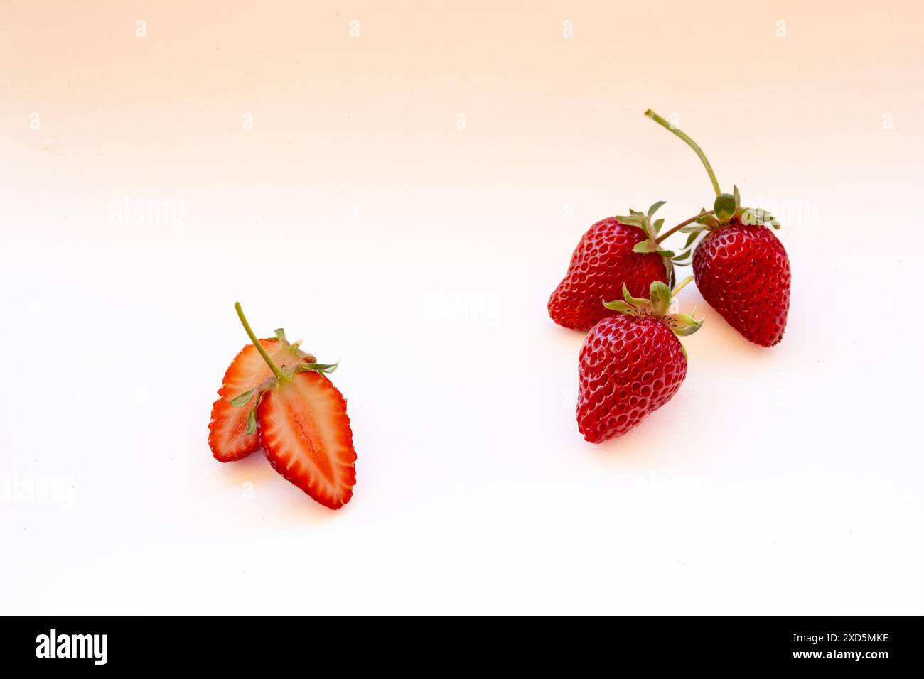 Three whole handpicked organic strawberries and one cut in half ...