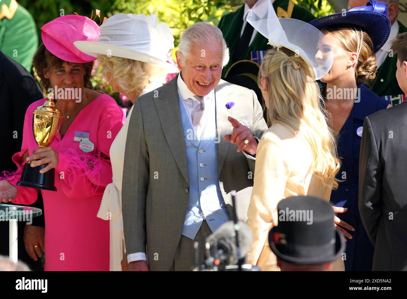 King Charles III (centre) speaks with the winning entourage following ...