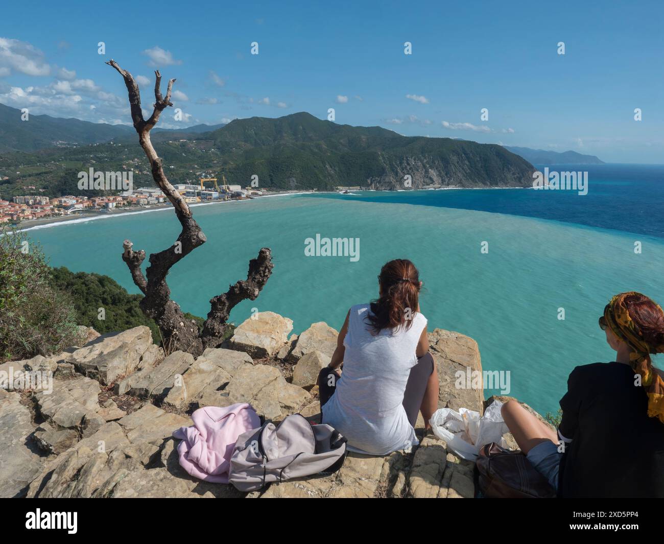 Two woman tourists figure from behind watching aerial view on Riva ...