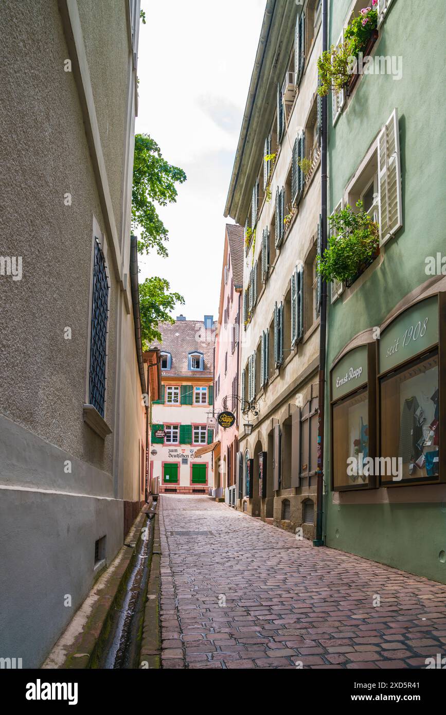 Freiburg im Breisgau, Germany, July 23, 2023, Narrow cobblestone street ...