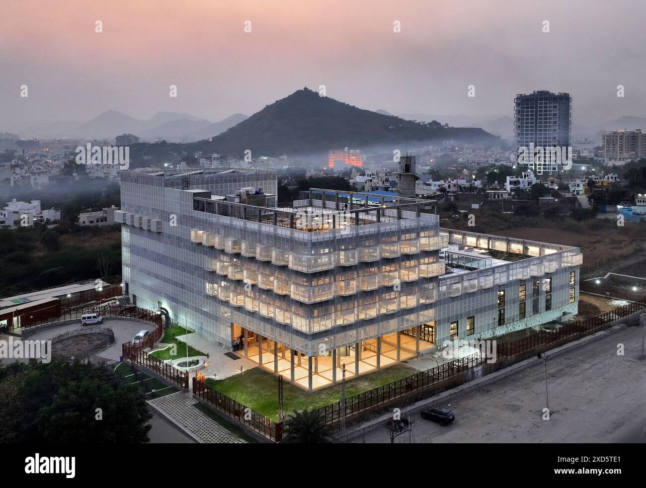 Aerial view of discovery centre in context at dusk. Third Space, Udaipur, India. Architect ...