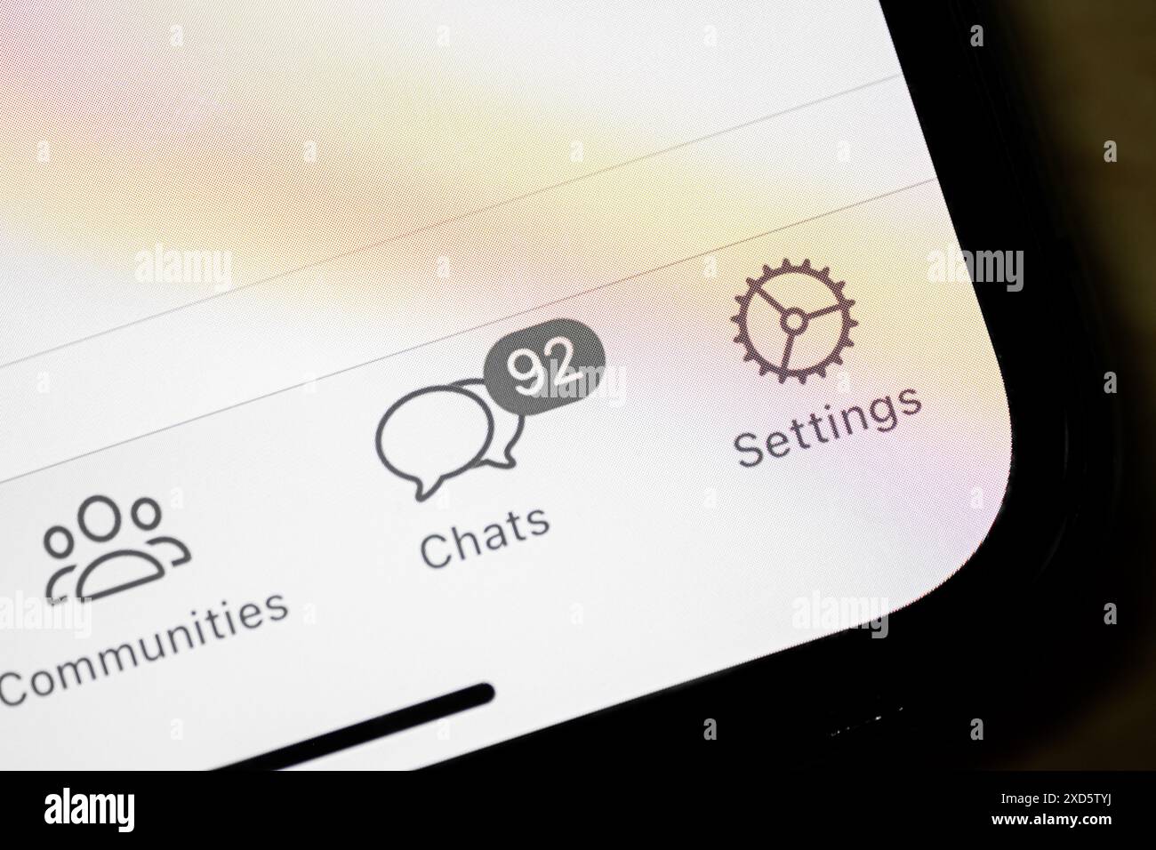 Close-up of a smart phone screen showing 92 unread messages in a chat ...