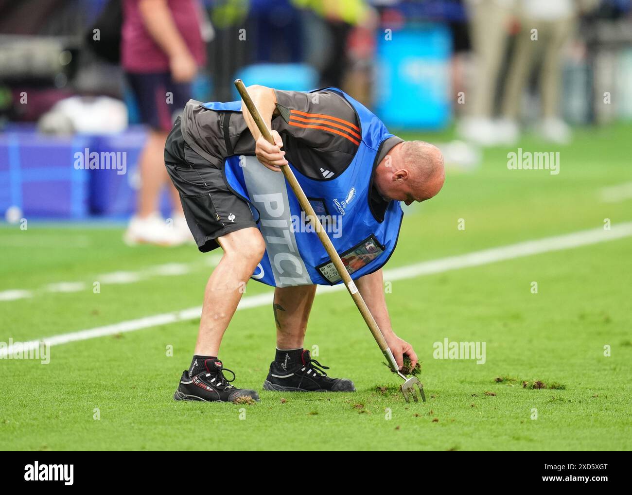 Ground staff tend to divots in the turf at half-time during the UEFA ...