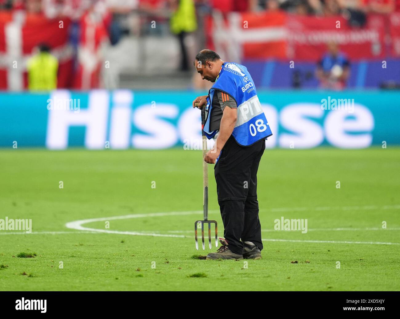 Ground staff tend to divots in the turf at half-time during the UEFA ...