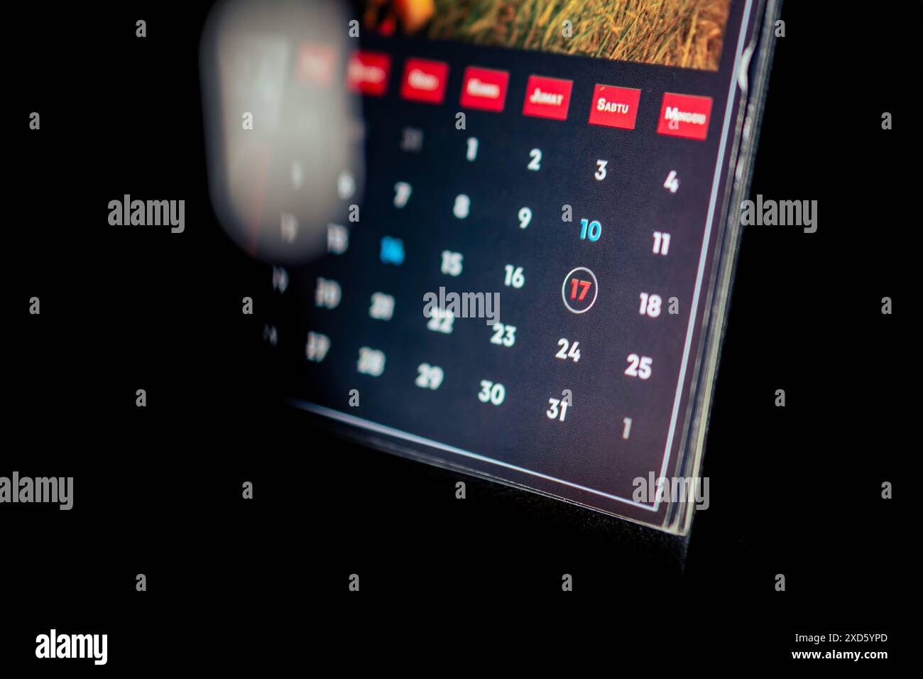 A close-up of a calendar page showing the dates and days of the week ...