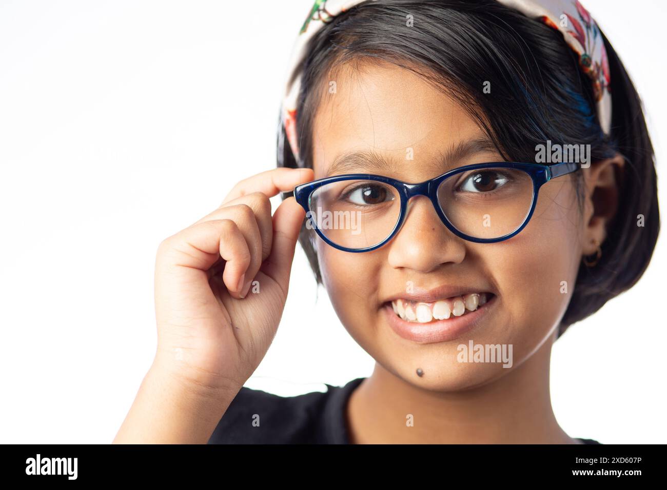 Head shot portrait of a young beautiful Indian girl child wearing dark ...