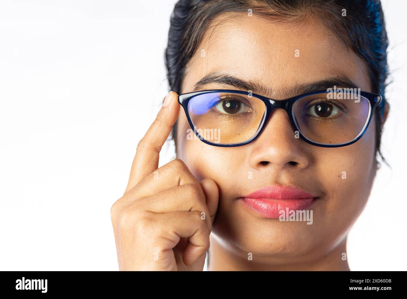 Head shot portrait of a young beautiful Indian female wearing dark ...