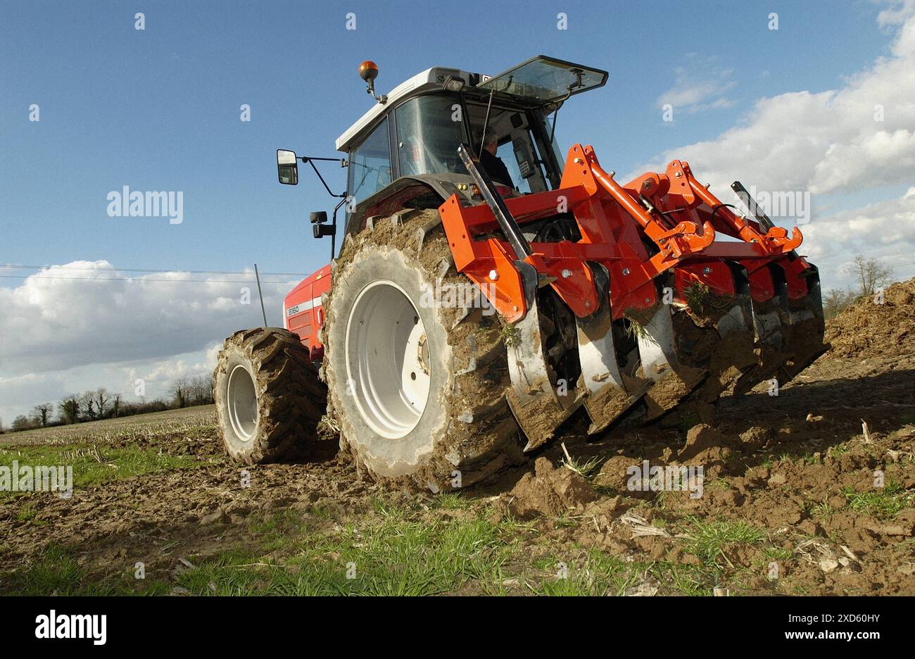 Tractor with plow at field Stock Photo - Alamy