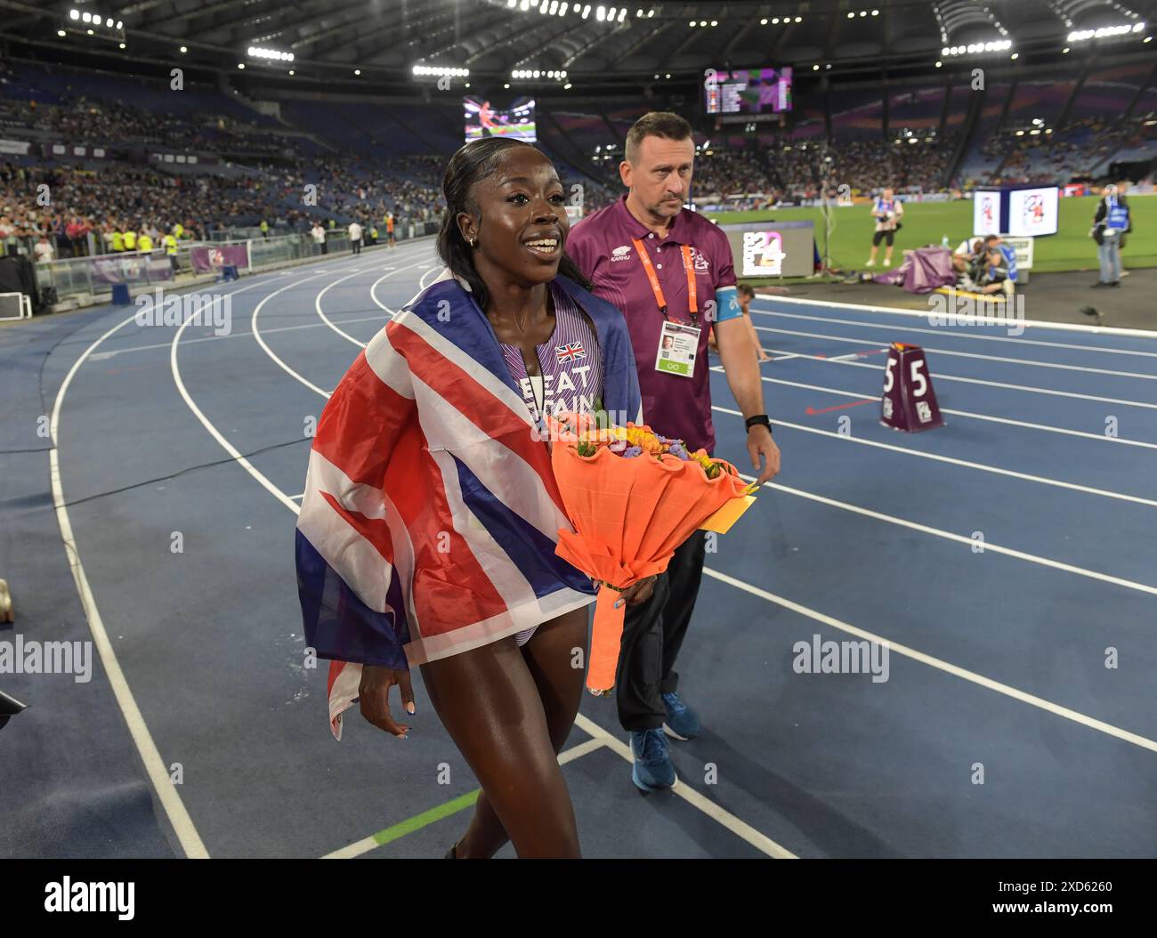Desiree Henry of Great Britain escorted of the track by an official ...