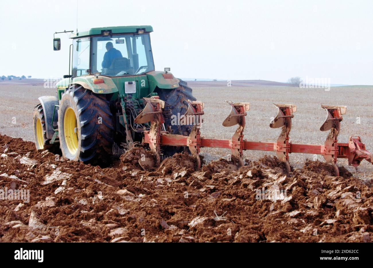 Tractor dragging a plough Stock Photo - Alamy