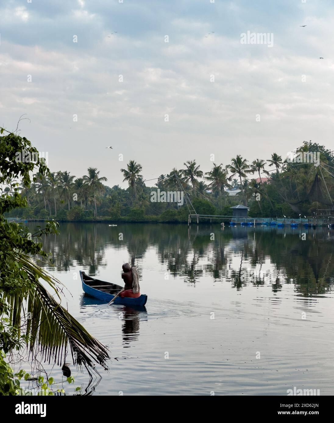 Kochi, Keral, India - May 14, 2024: A localite moving around in a canoe ...
