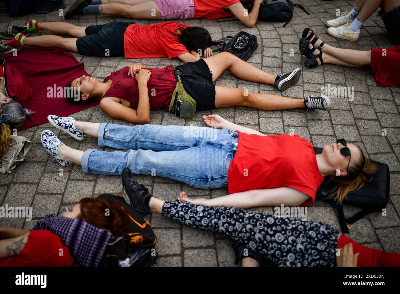 People lie on the ground recreate the aftermath of a bombing during a ...