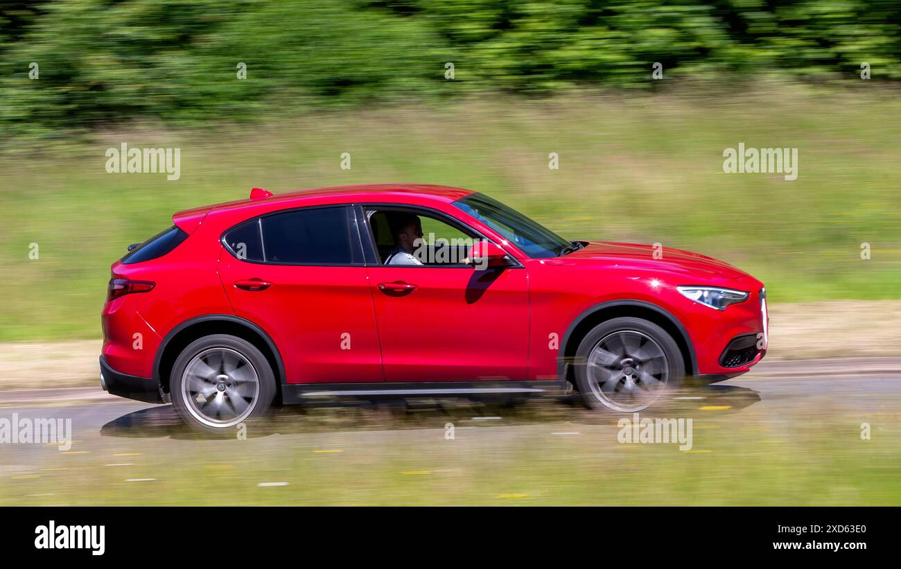 Milton Keynes,UK - June 20th 2024: 2019 red Alfa Romeo car driving on a ...