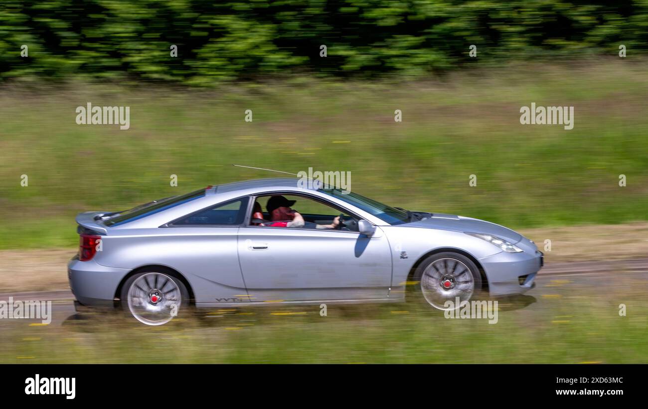 Milton Keynes,UK - June 20th 2024: 2005 silver Toyota Celica car driving on a British country ...