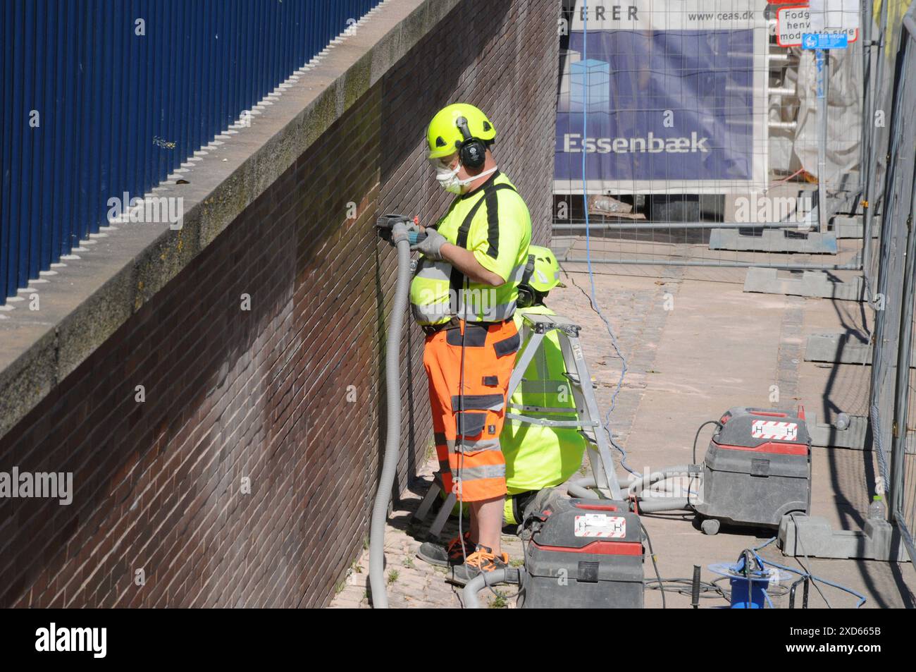 Copenhagen/ Denmark/20 JUNE 2024/ Worker cleaning of washing brick wall ...