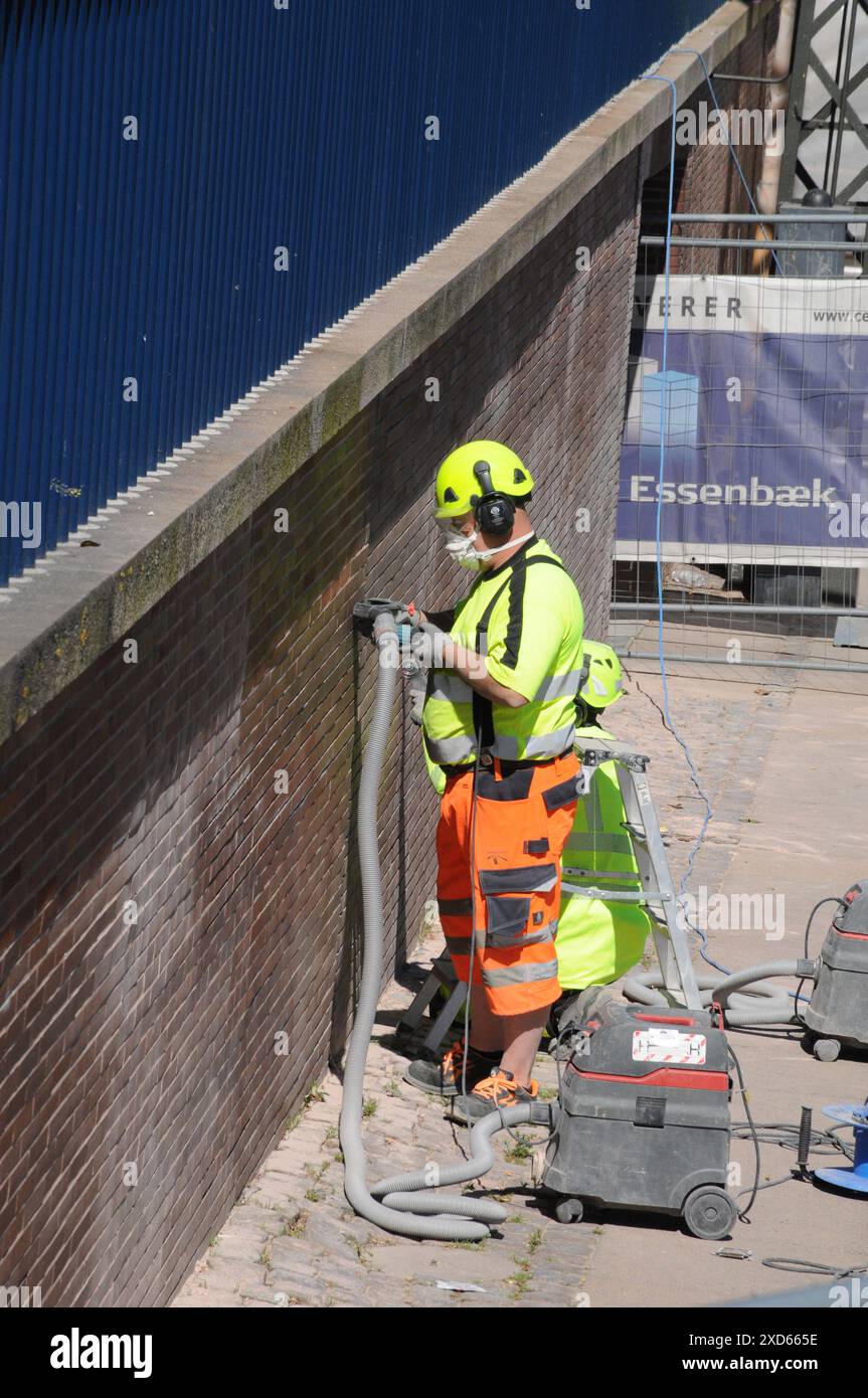 Copenhagen/ Denmark/20 JUNE 2024/ Worker cleaning of washing brick wall ...