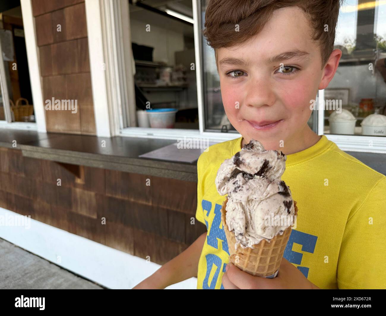 Silas Pociask, 9, of Deerfield, N.H., enjoys a "kiddie"-sized ice cream ...