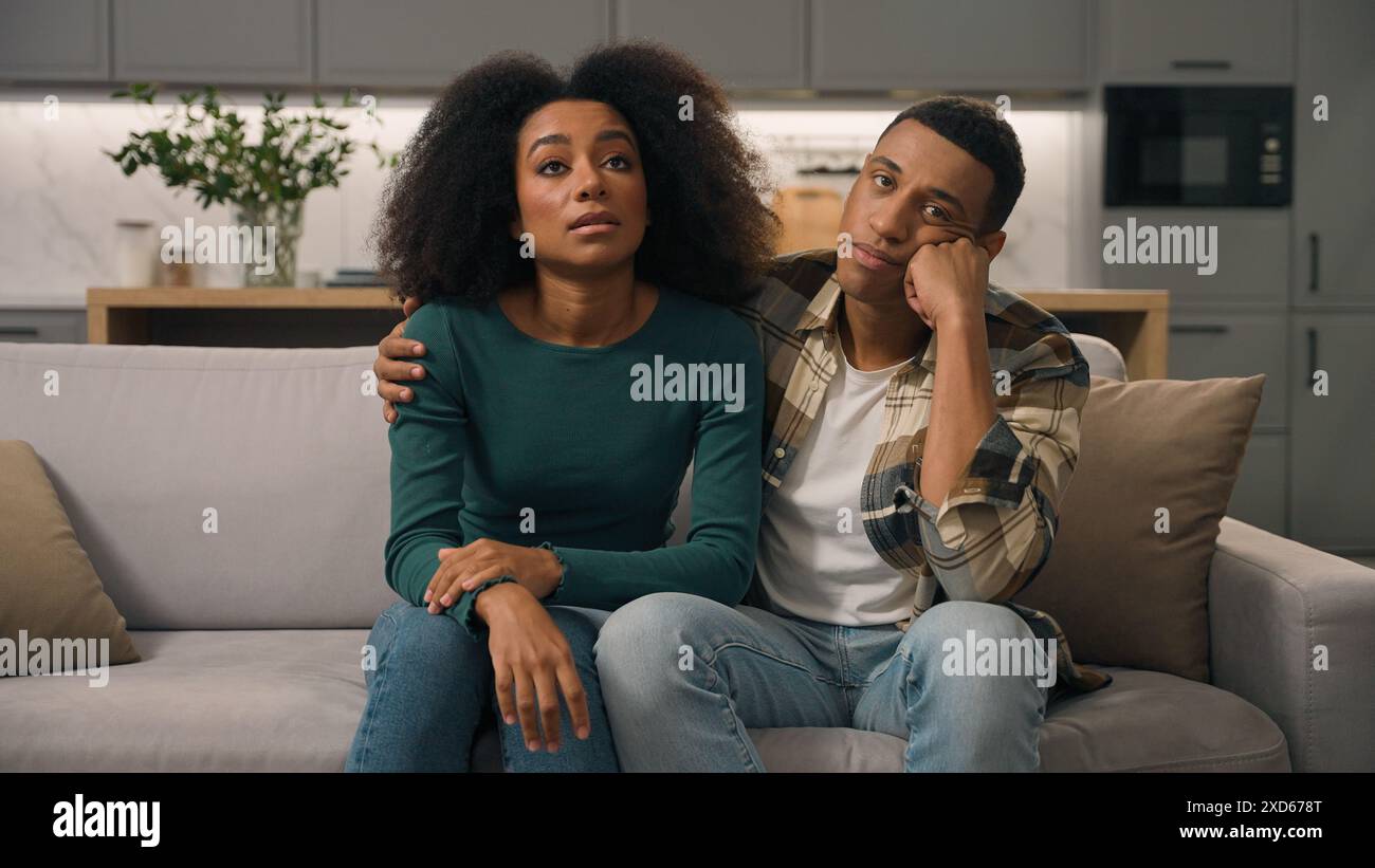 Annoyed African American ethnic exhausted young couple disturbed ...