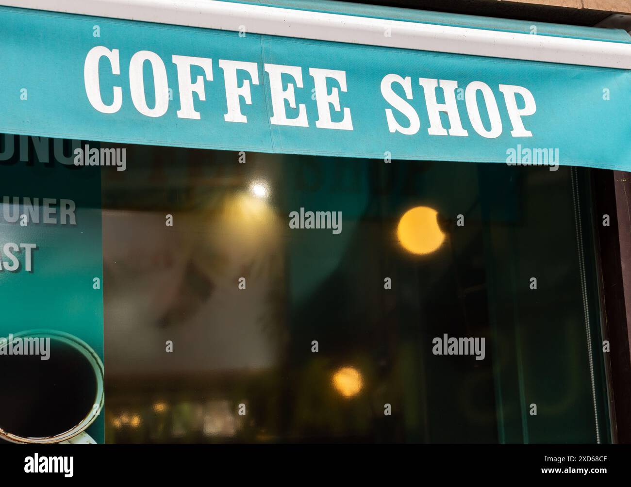 Blue coffee shop awning sign with white letters over the window with ...